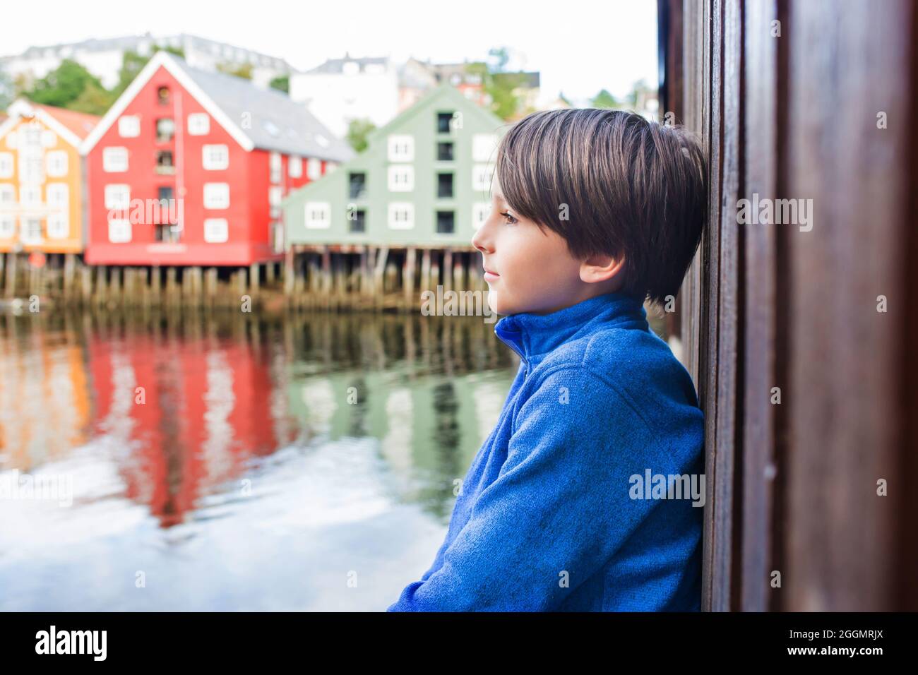 Cute child, boy, visiting Trondheim, Norway during the summer, enjoying ...
