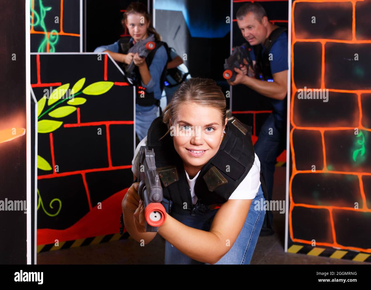 Woman playing lasertag with family Stock Photo - Alamy