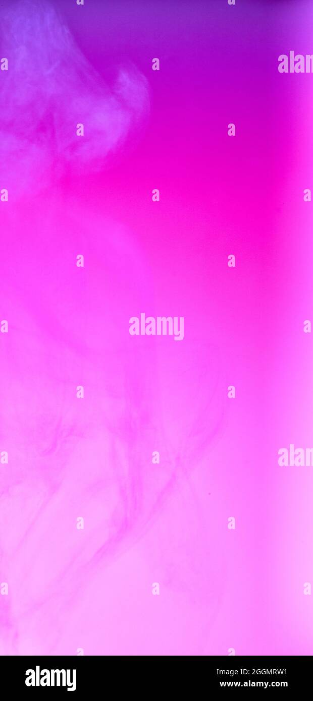 Smoke rising from diffuser with red blue purple neon gradient light ...