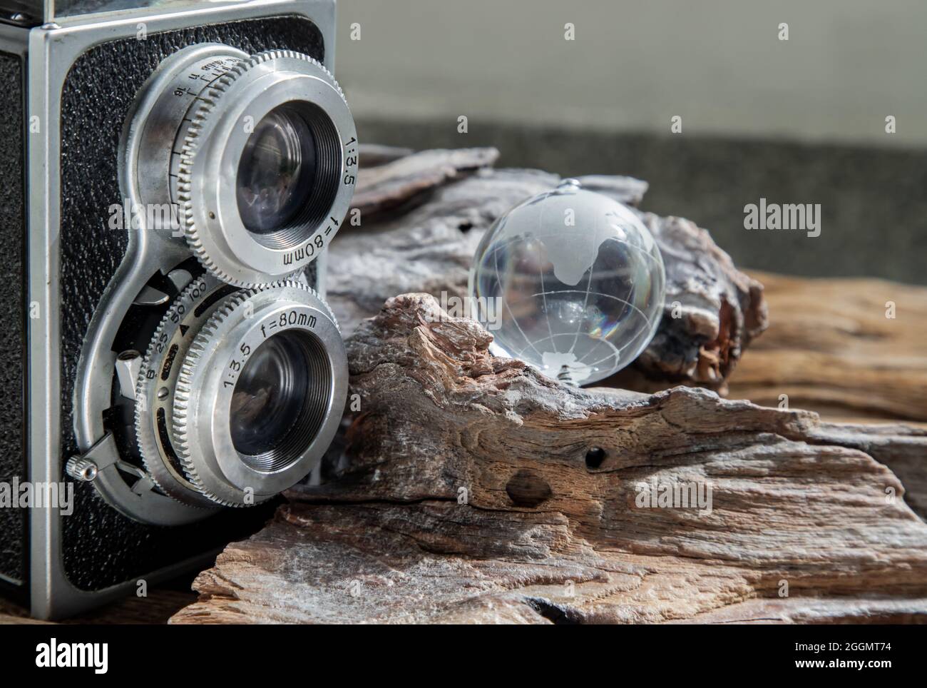 Vintage two lens photo camera with Glass crystal globe on wooden ...