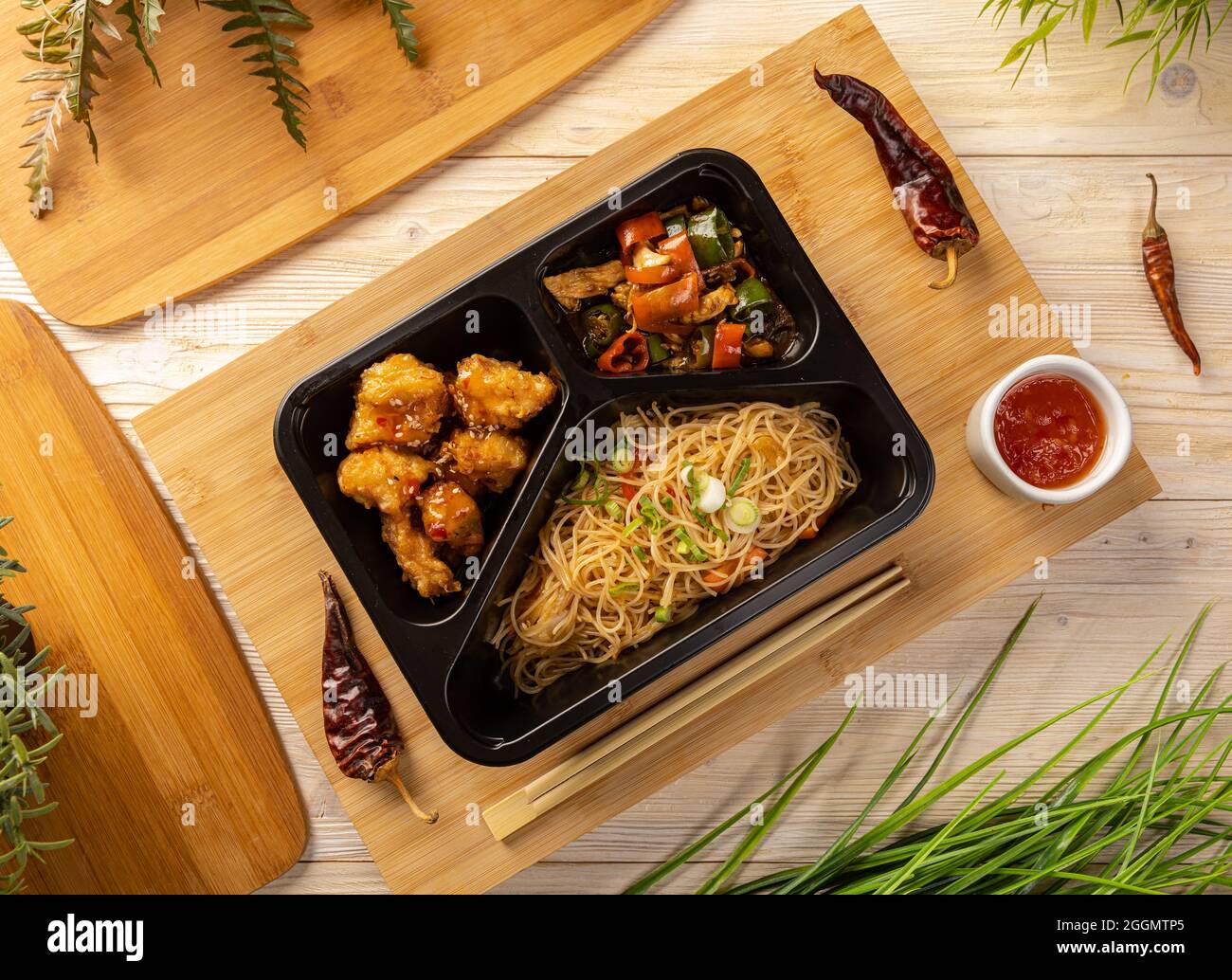 Flat lay of noodles with chicken stew and breaded chicken cubes in take ...