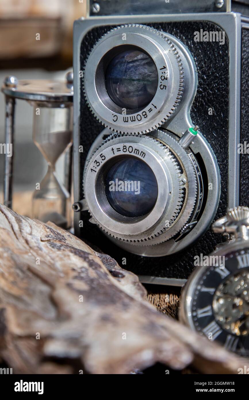 Vintage two lens photo camera with A retro pocket watch on wooden ...