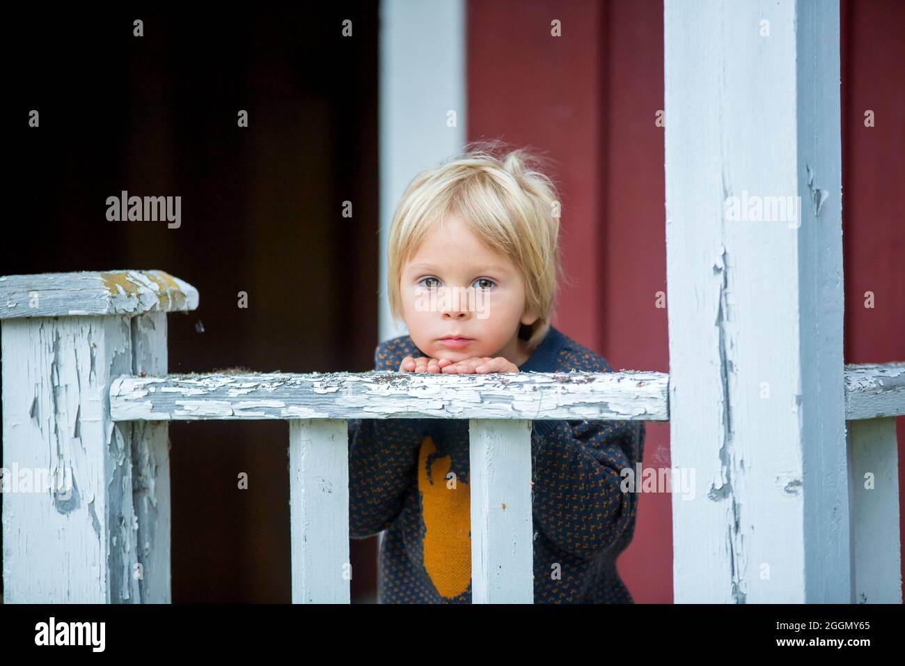 Sad little child, preschool boy, sitting on stairs in front of old ...
