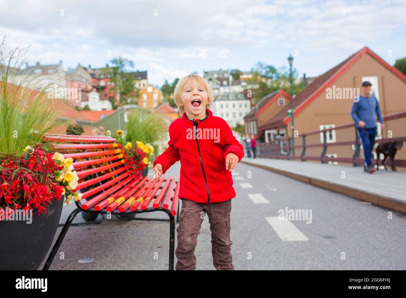 Cute child, boy, visiting Trondheim, Norway during the summer, enjoying ...