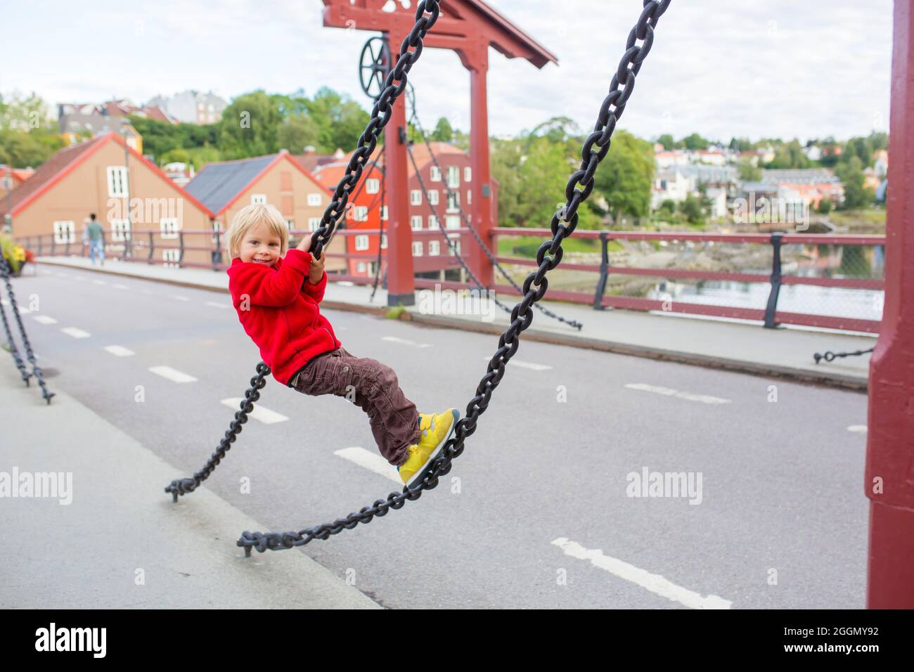 Cute child, boy, visiting Trondheim, Norway during the summer, enjoying ...