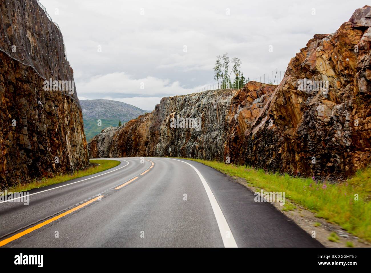 Road with rocks on both sides in Norway, Nordland, the main road to ...