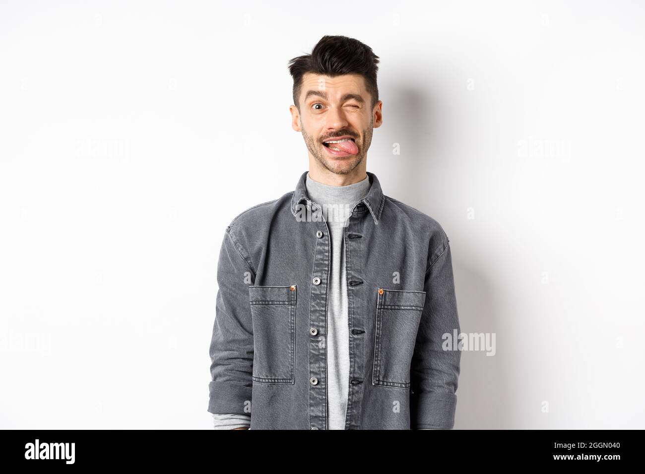 Funny guy with moustache showing tongue and winking, making you laugh ...
