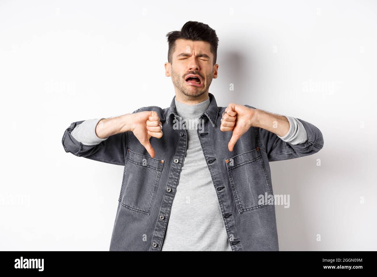 Sad man crying and showing thumbs down, whining and complainin, being ...