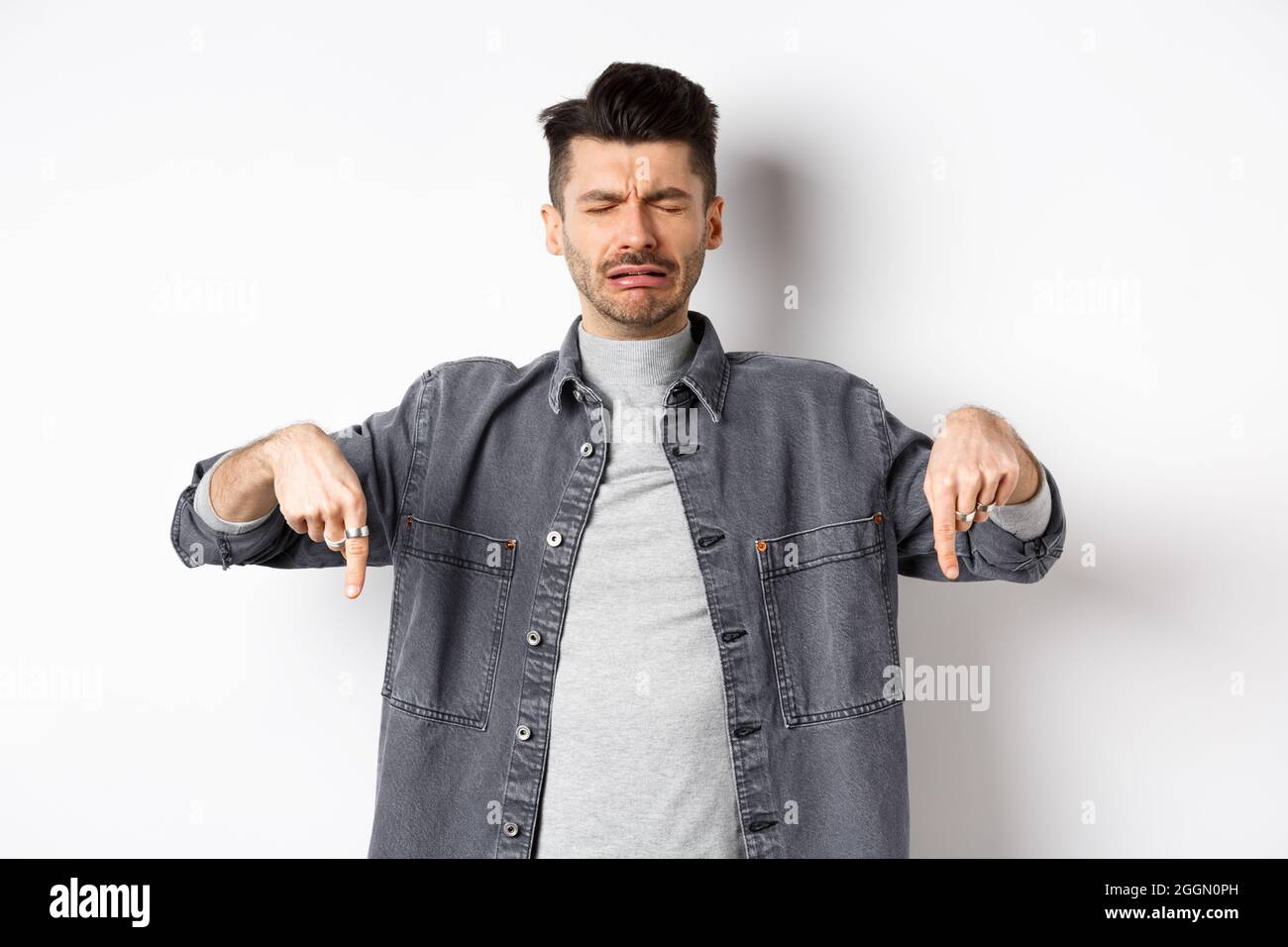 Sad crying man whining, pointing fingers down disappointed, showing bad ...