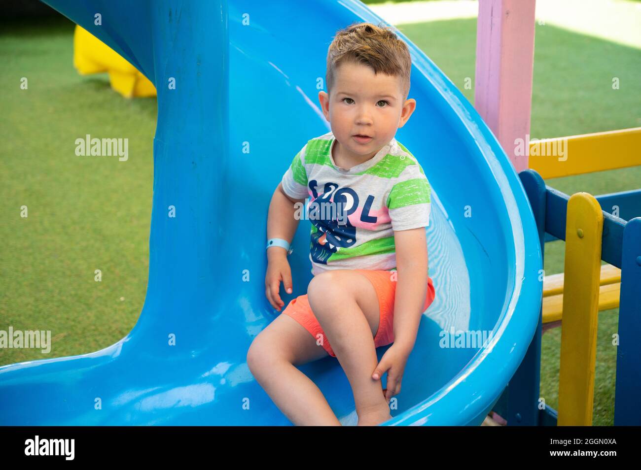 The child is afraid of rolling down the children's slide Stock Photo ...