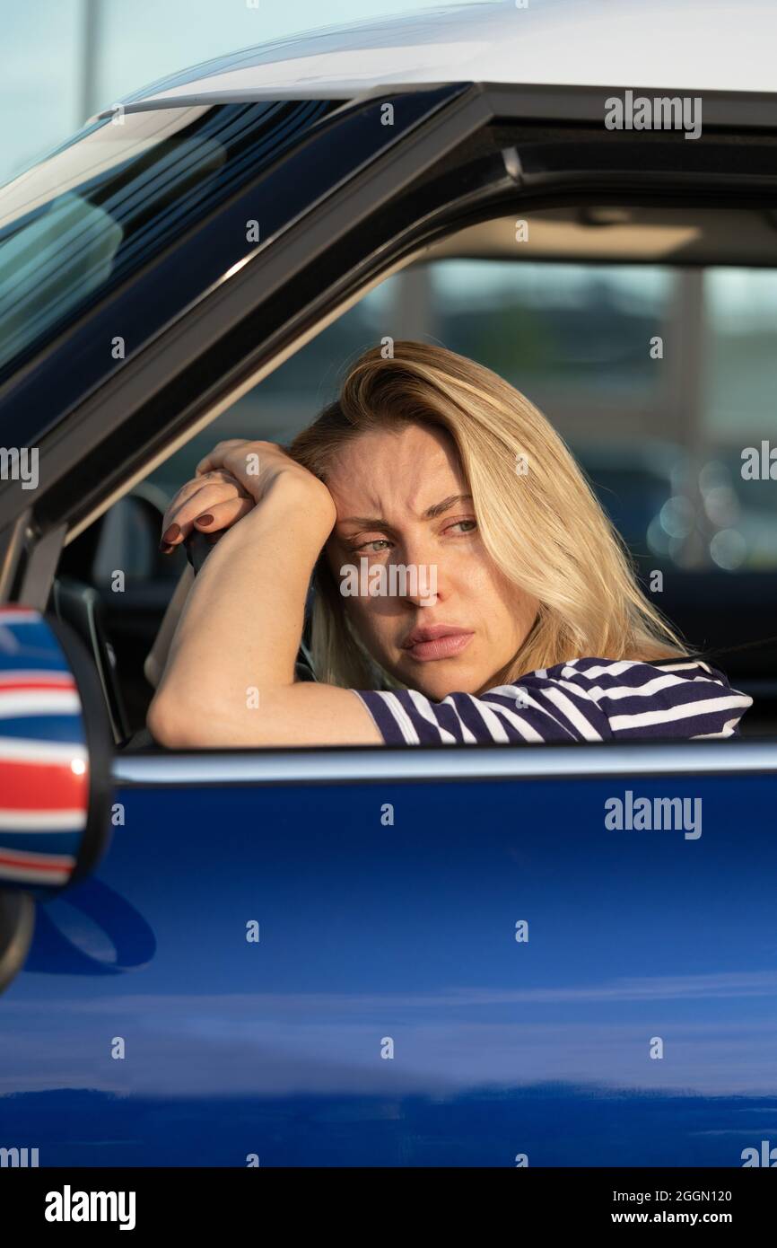 Frustrated woman driver in car wait for tow truck. Sad female tired of ...
