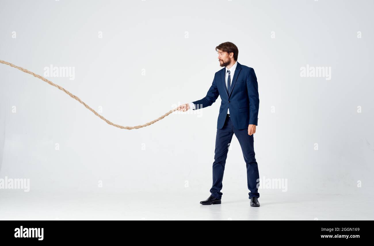 Man in action of pulling rope hi-res stock photography and images - Alamy