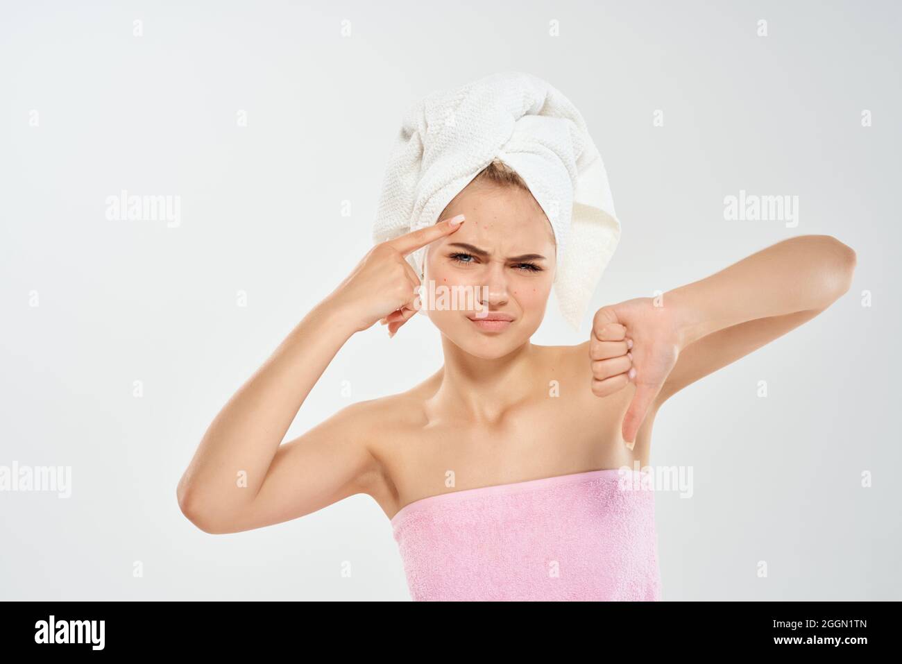 woman with towel on head holding face skin care dermatology health ...