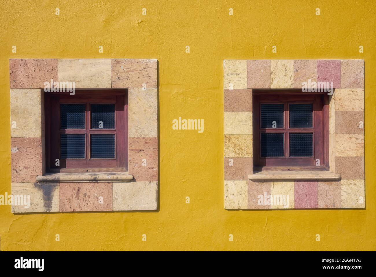 Closeup shot of square windows of a yellow building Stock Photo - Alamy