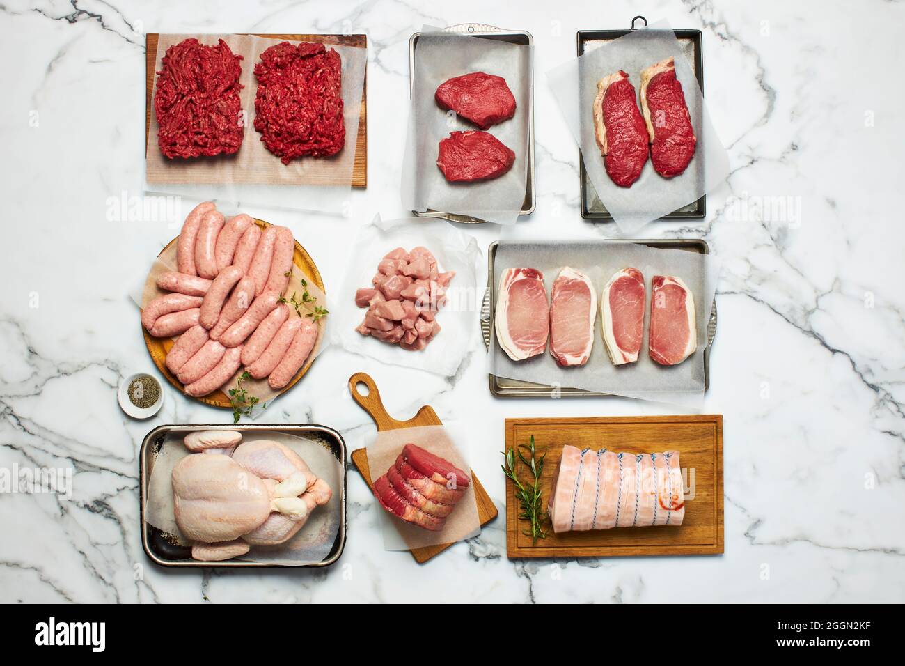 Various cuts of meat on a marble background Stock Photo - Alamy