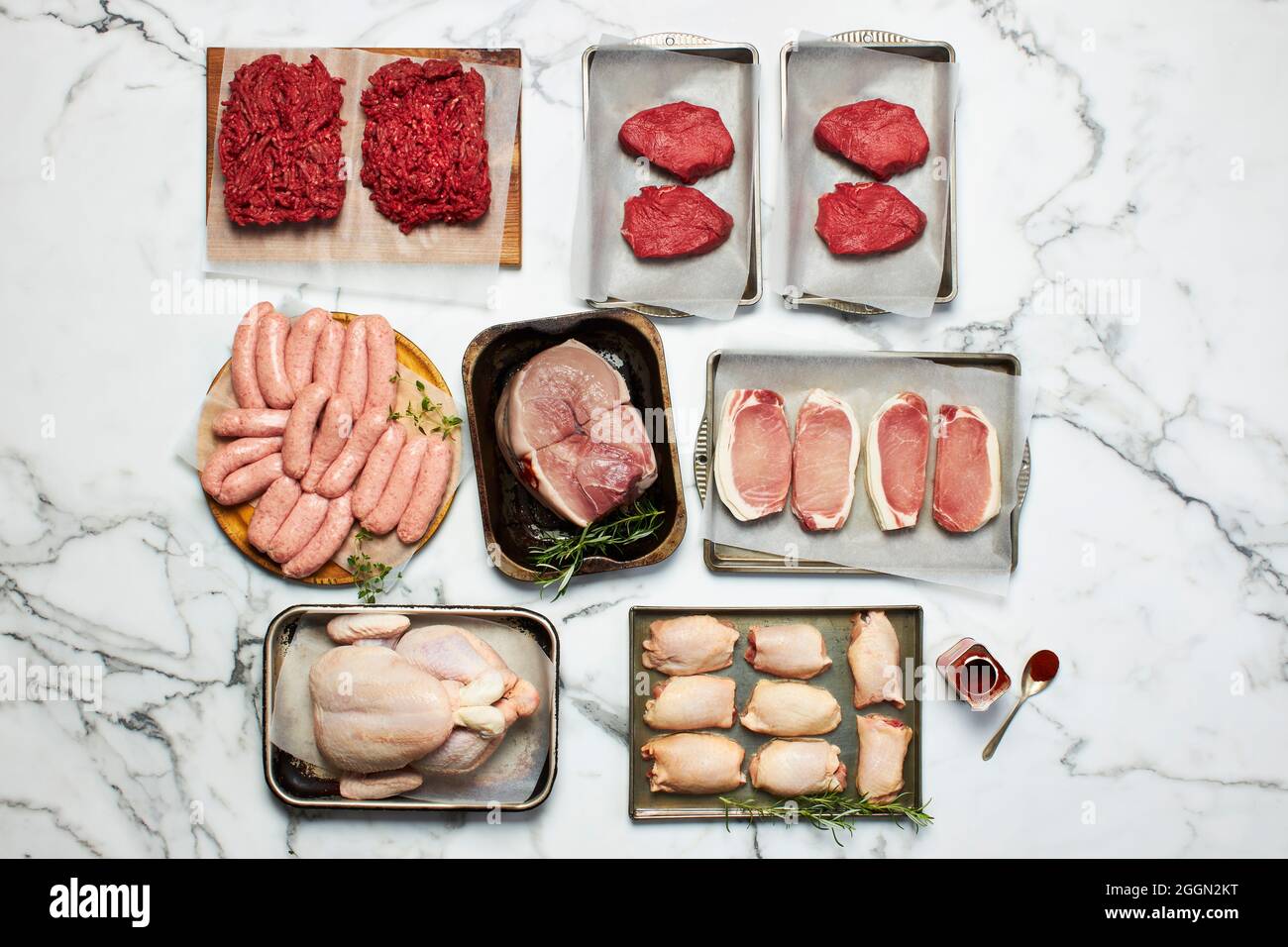 Various cuts of meat on a marble background Stock Photo - Alamy