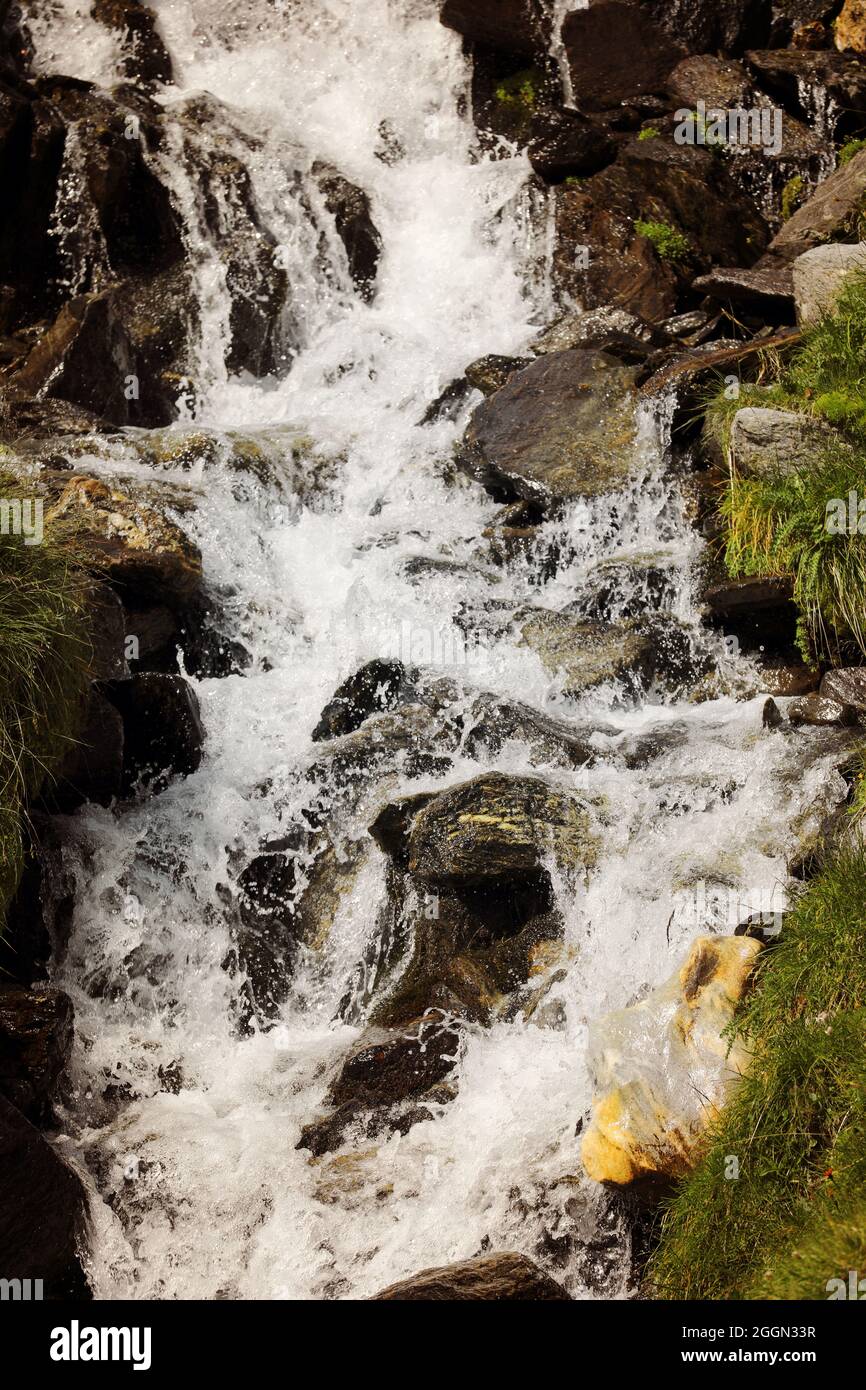 Cascade waterfall in the Alps Stock Photo - Alamy