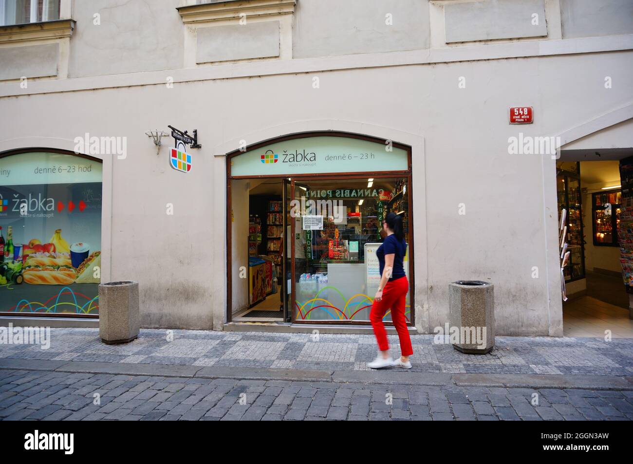 PRAGUE, CZECH REPUBLIC - Jul 26, 2019: A woman walking on a sidewalk in ...