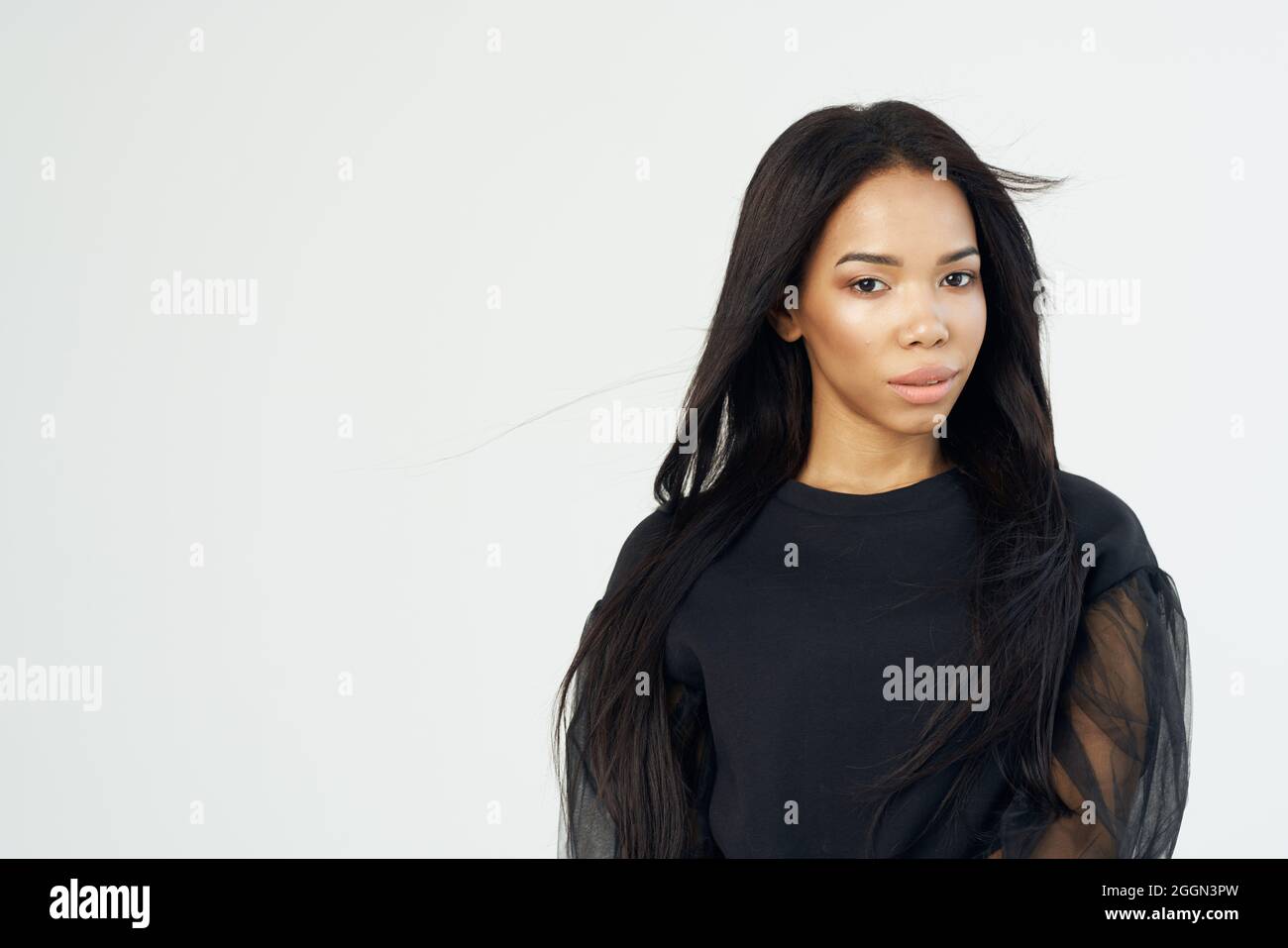 woman african appearance and long dark hair posing studio Stock Photo ...
