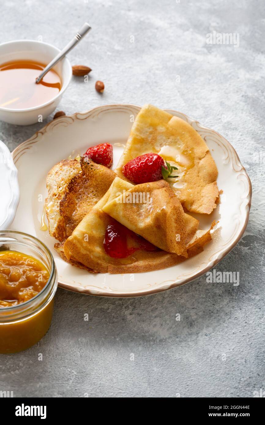 Close up of crepes with jam on plate, breakfast Stock Photo - Alamy