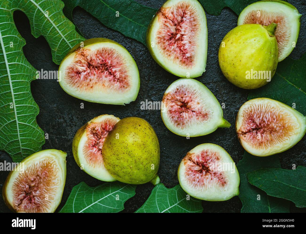 Fresh fig fruits and leaves on a black board Stock Photo - Alamy