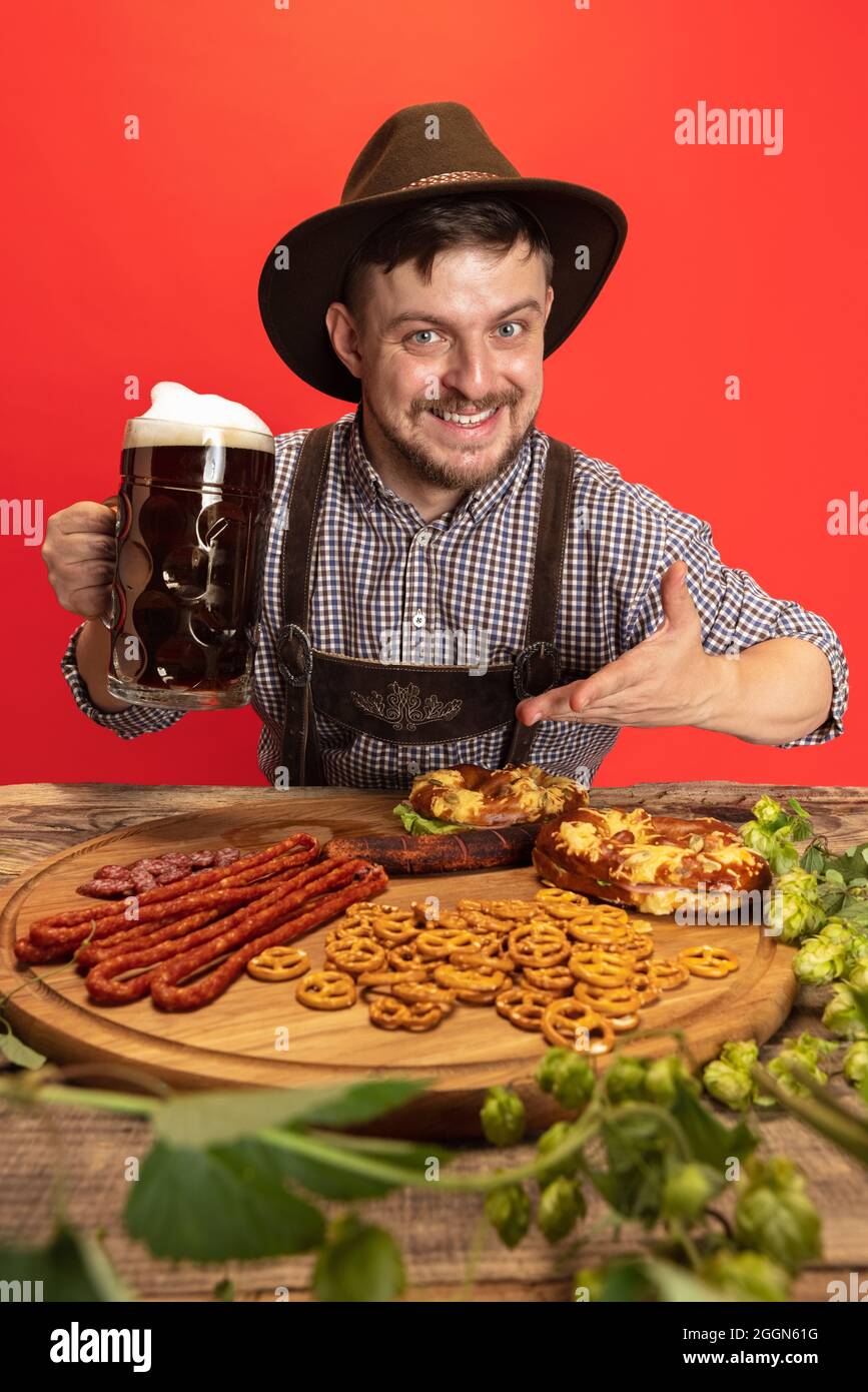 Happy smiling man dressed in traditional Austrian or Bavarian costume ...