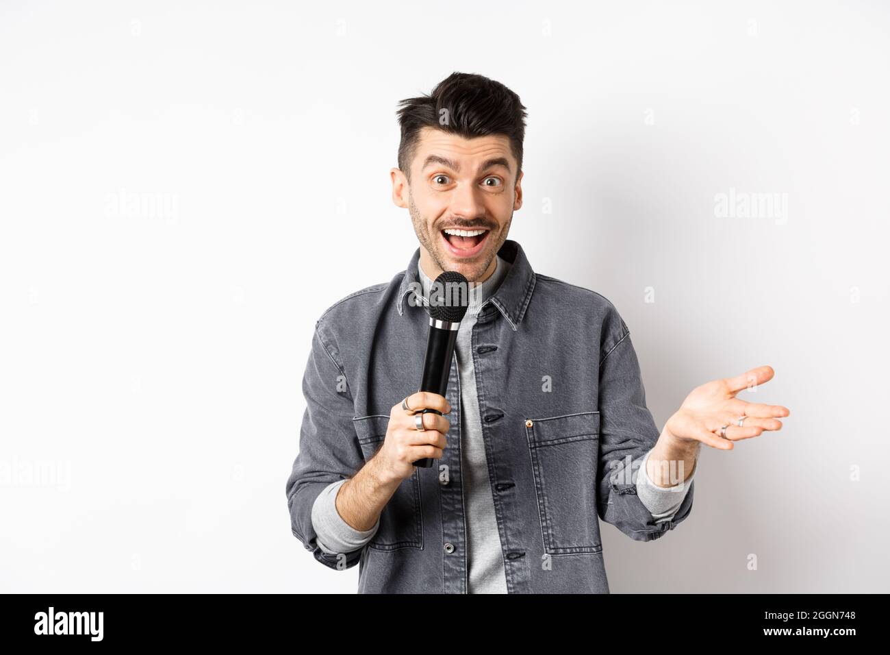 Handsome smiling performer talking in mic, gesturing and performing ...