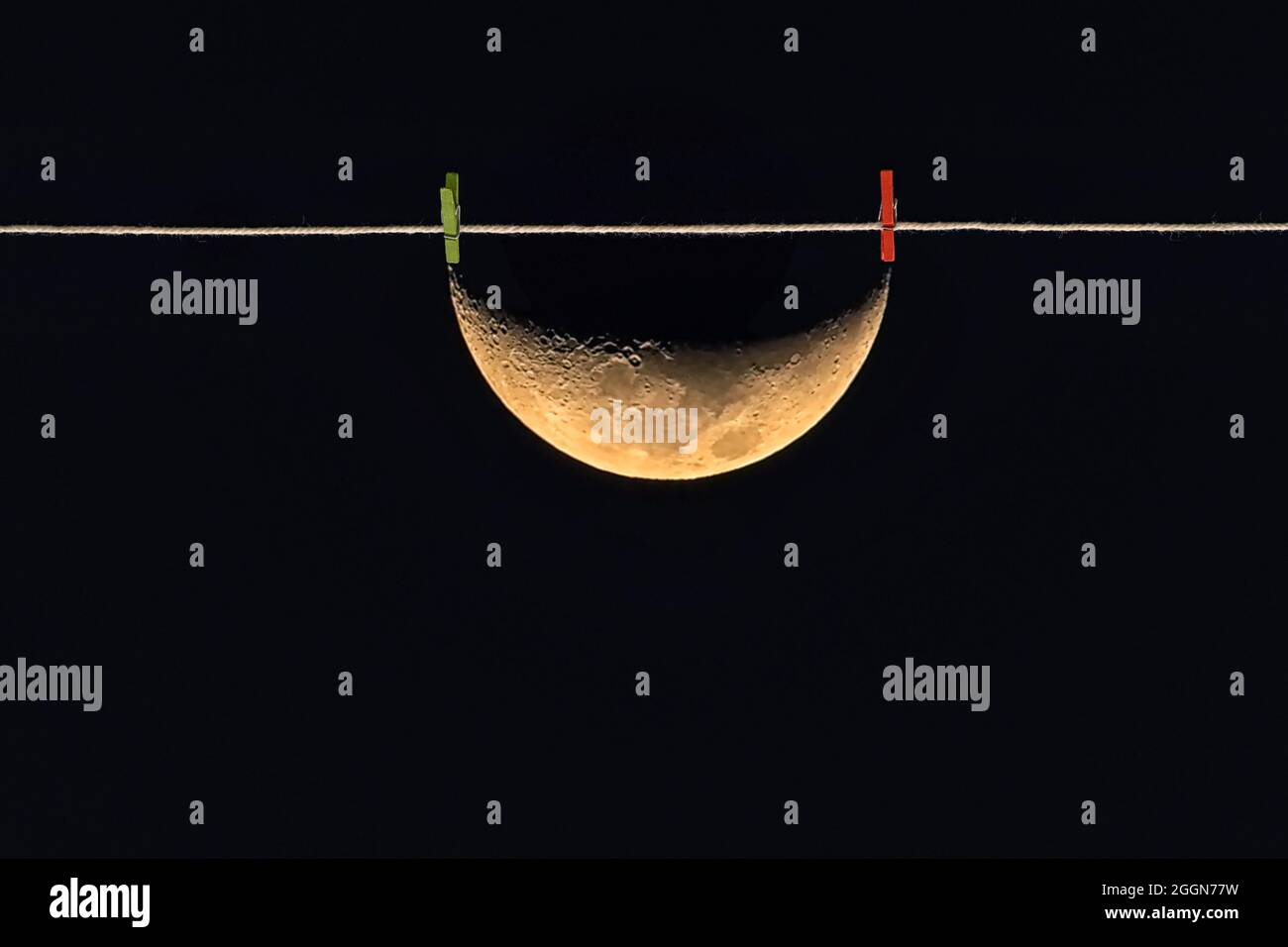 Abstract Half Moon on Laundry Rope in Night Sky Stock Photo - Alamy