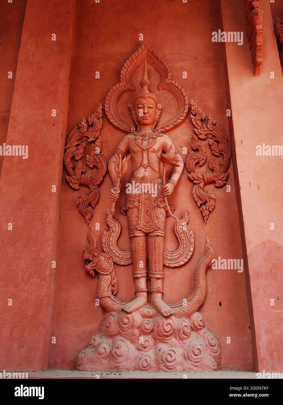 Temple of red color in Thailand. The facade of the temple is decorated ...