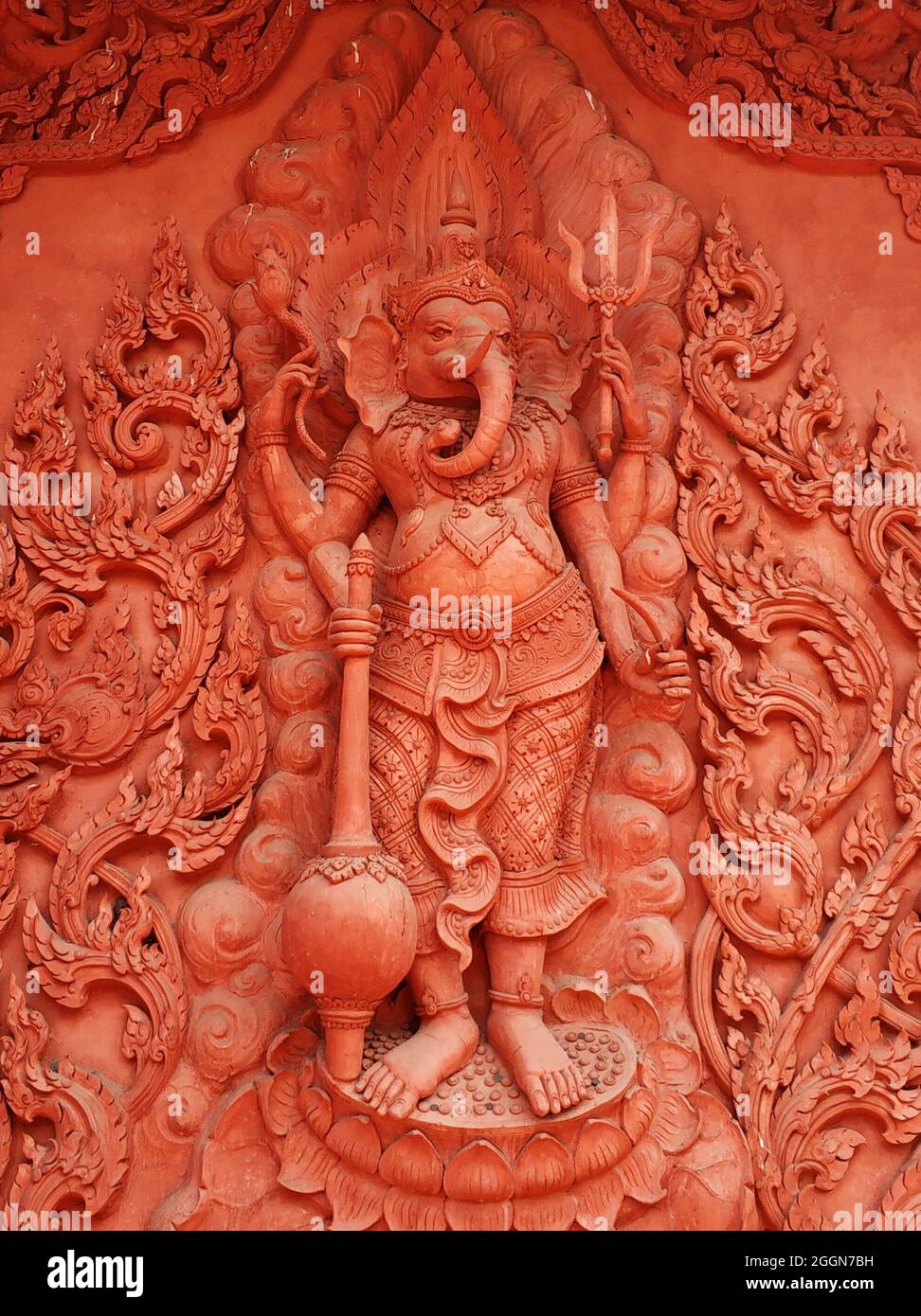 Temple of red color in Thailand. The facade of the temple is decorated ...