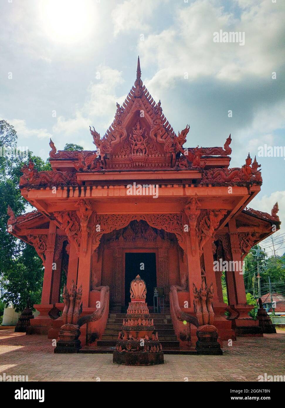 Temple of red color in Thailand. The facade of the temple is decorated ...