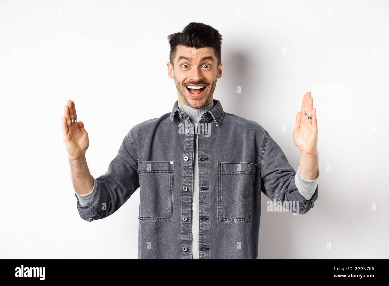 Happy guy with moustache showing big size with proud excited smile ...