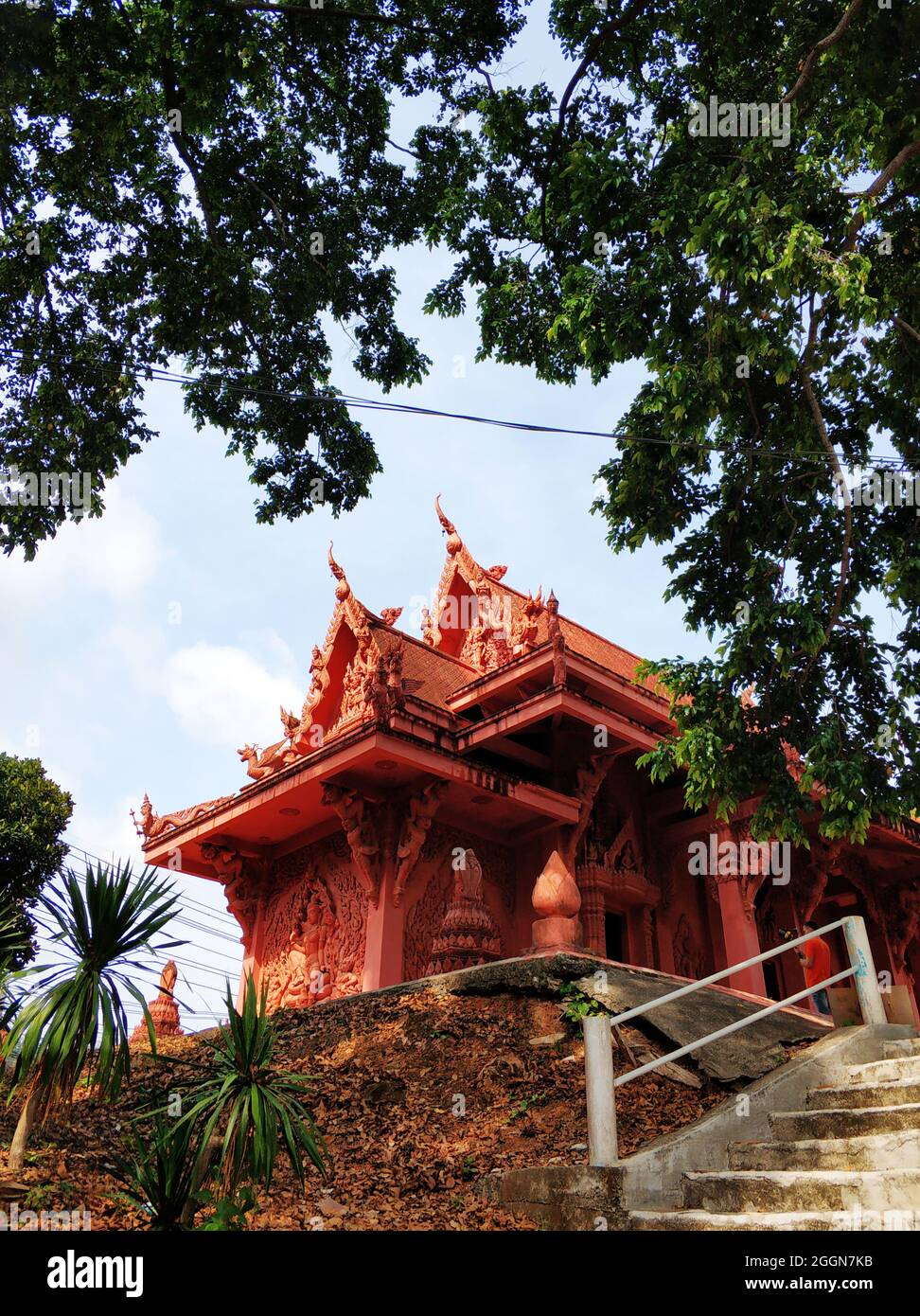 Temple of red color in Thailand. The facade of the temple is decorated ...