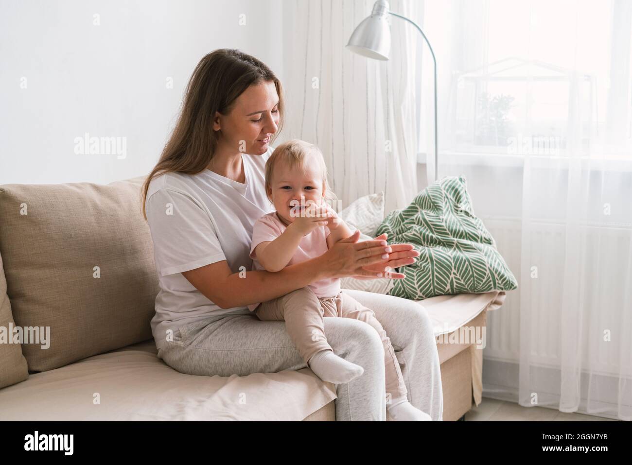 Mom sitting baby on knees hi-res stock photography and images - Alamy