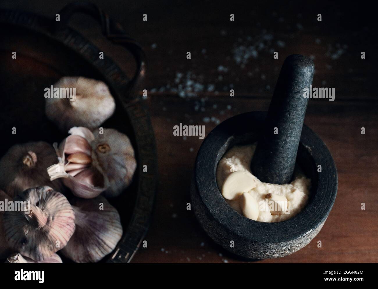 Garlic paste inside stone mortar Stock Photo - Alamy