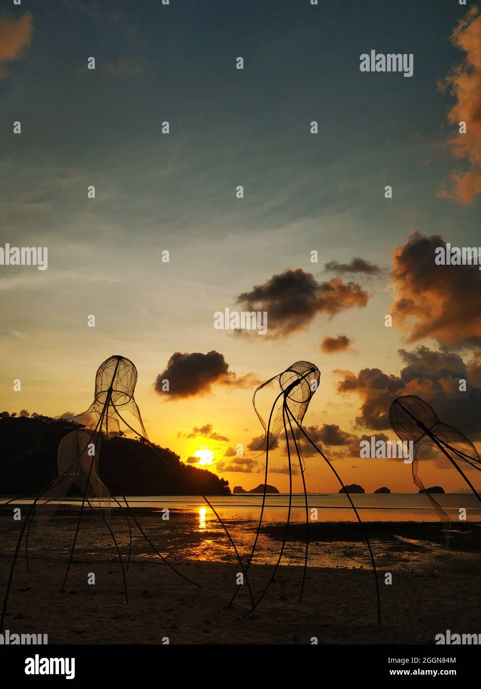 Colorful sunset on the beach. Reflection of the sunset sky in the water ...