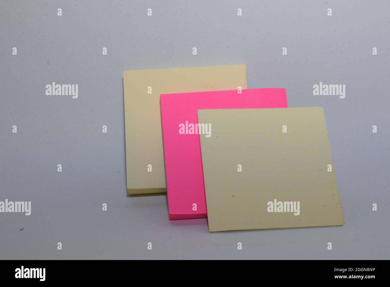 Rectangular sticky notepad. Fuchsia pink and yellow colors on white ...
