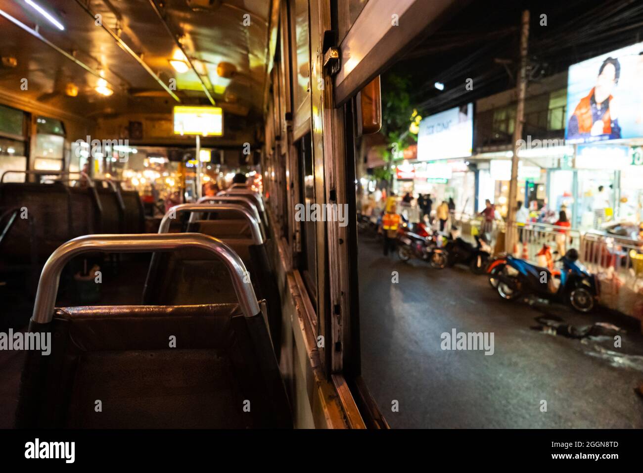 Ride in an empty bus through the city at night. City bus interior ...