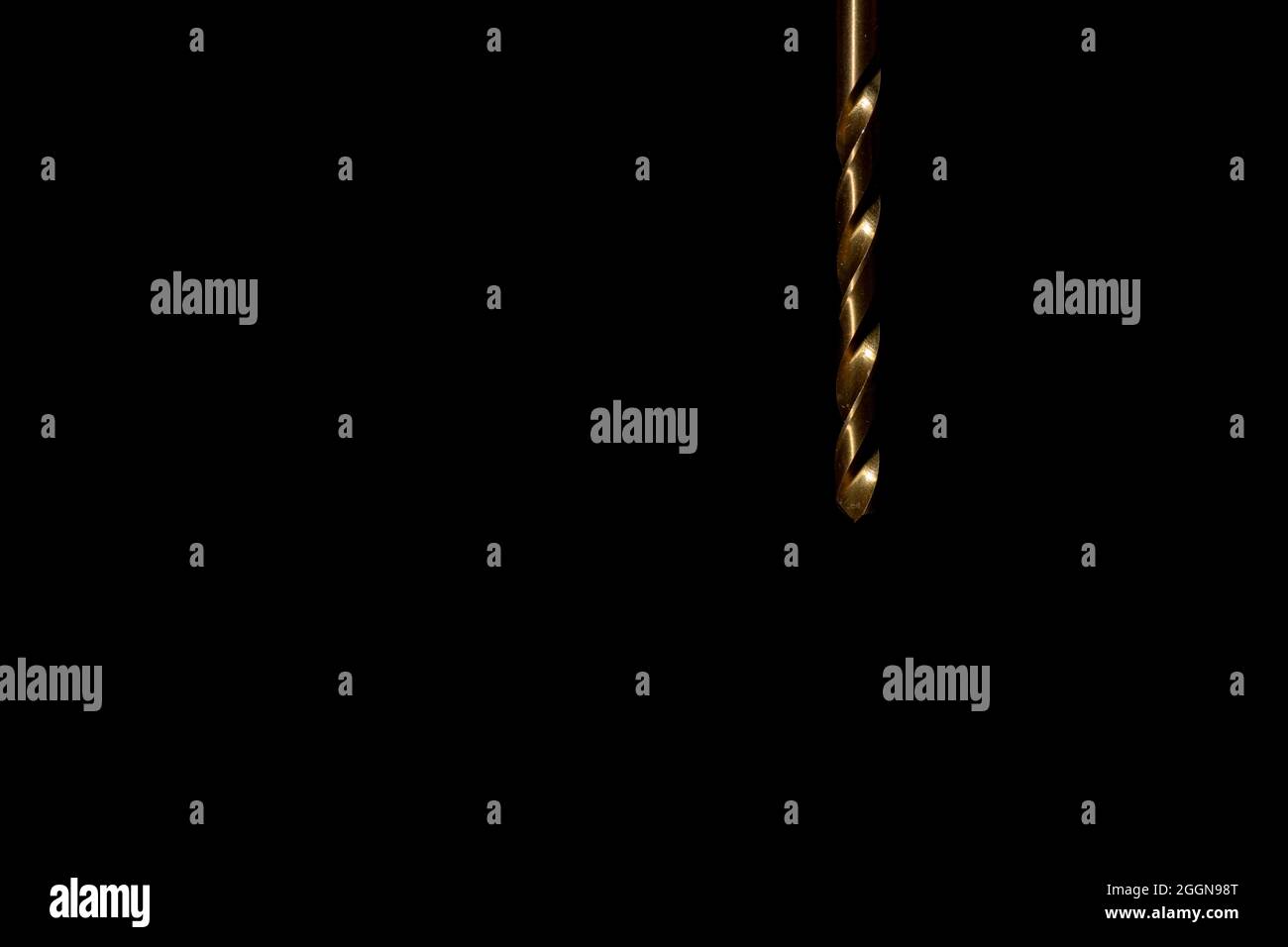 Close-up of a steel drill bit, black background, low key. One drill bit ...