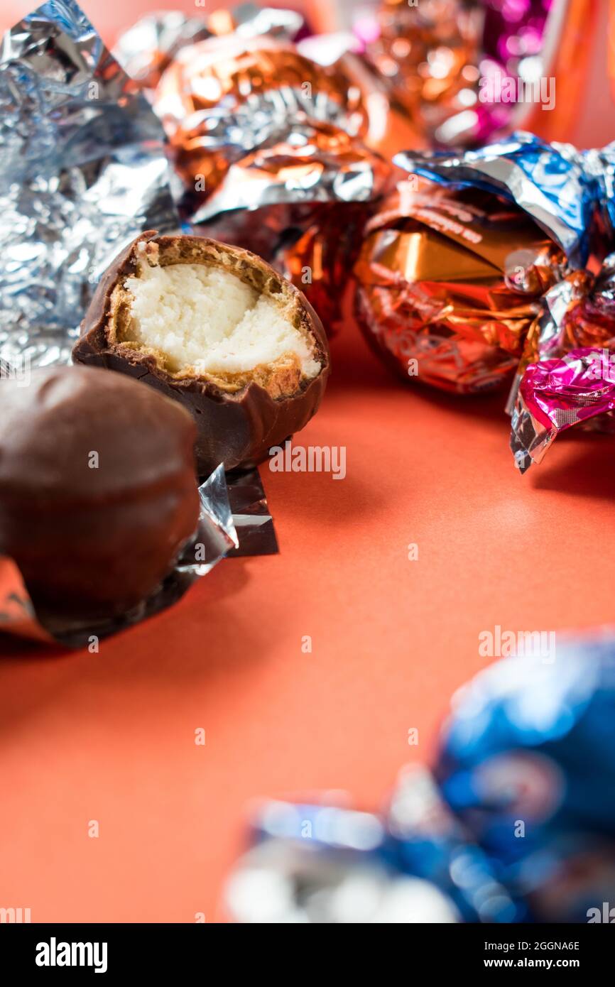 Vertical closeup shot of unwrapped half-eaten chocolate candies Stock ...
