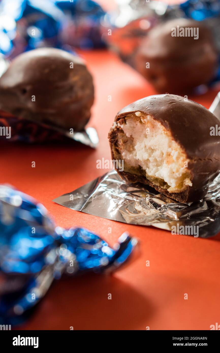 Vertical closeup shot of unwrapped half-eaten chocolate candies Stock ...