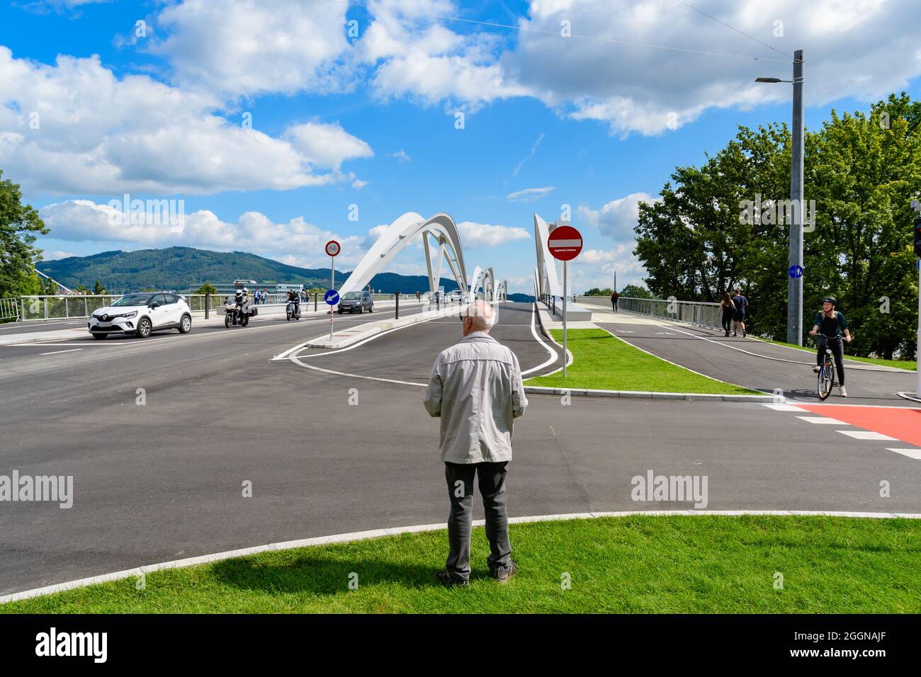 linz, austria, 01 sep 2021, old man watching the new bridge over the ...