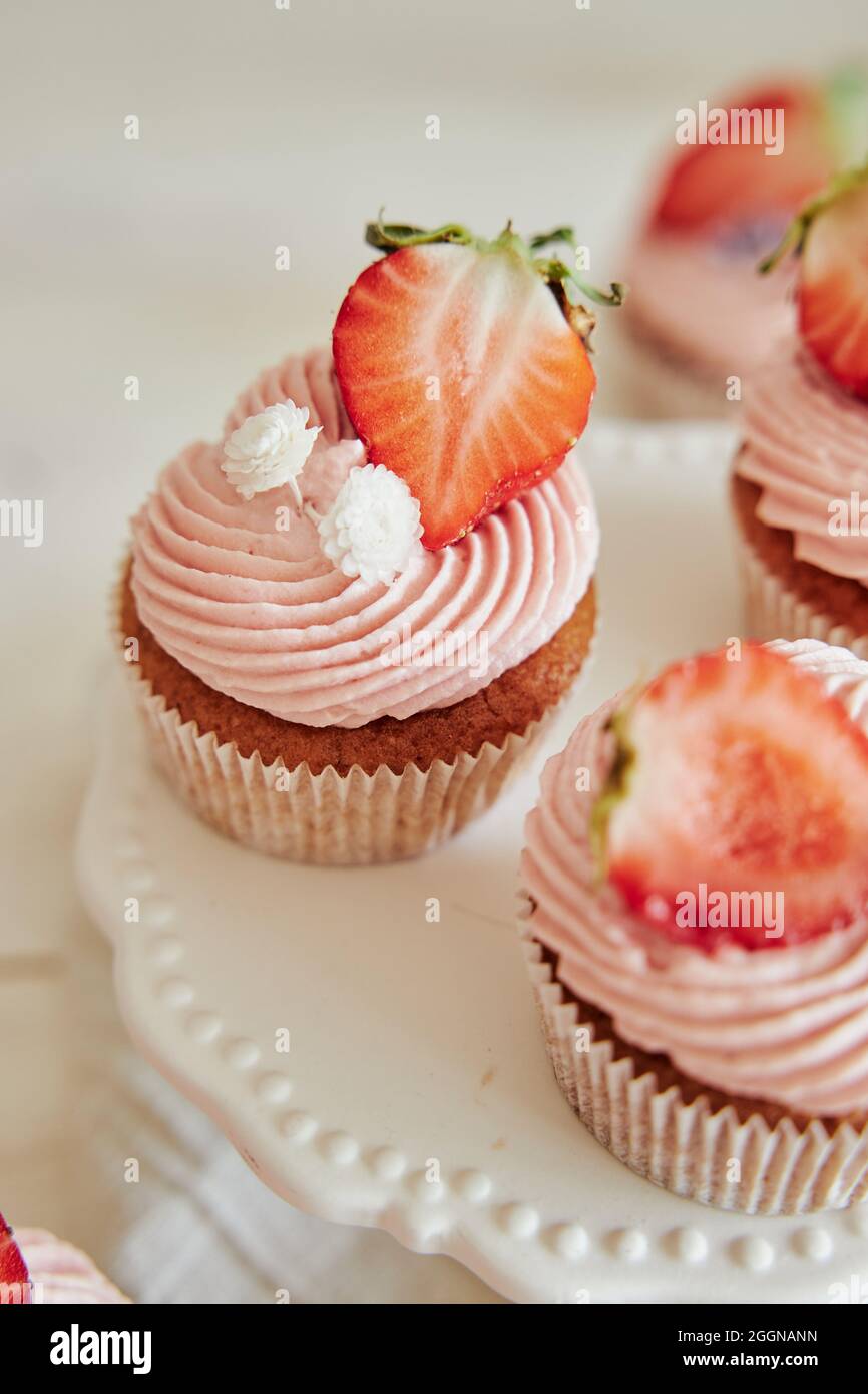 Vertical shot of delicious strawberry cupcakes Stock Photo - Alamy