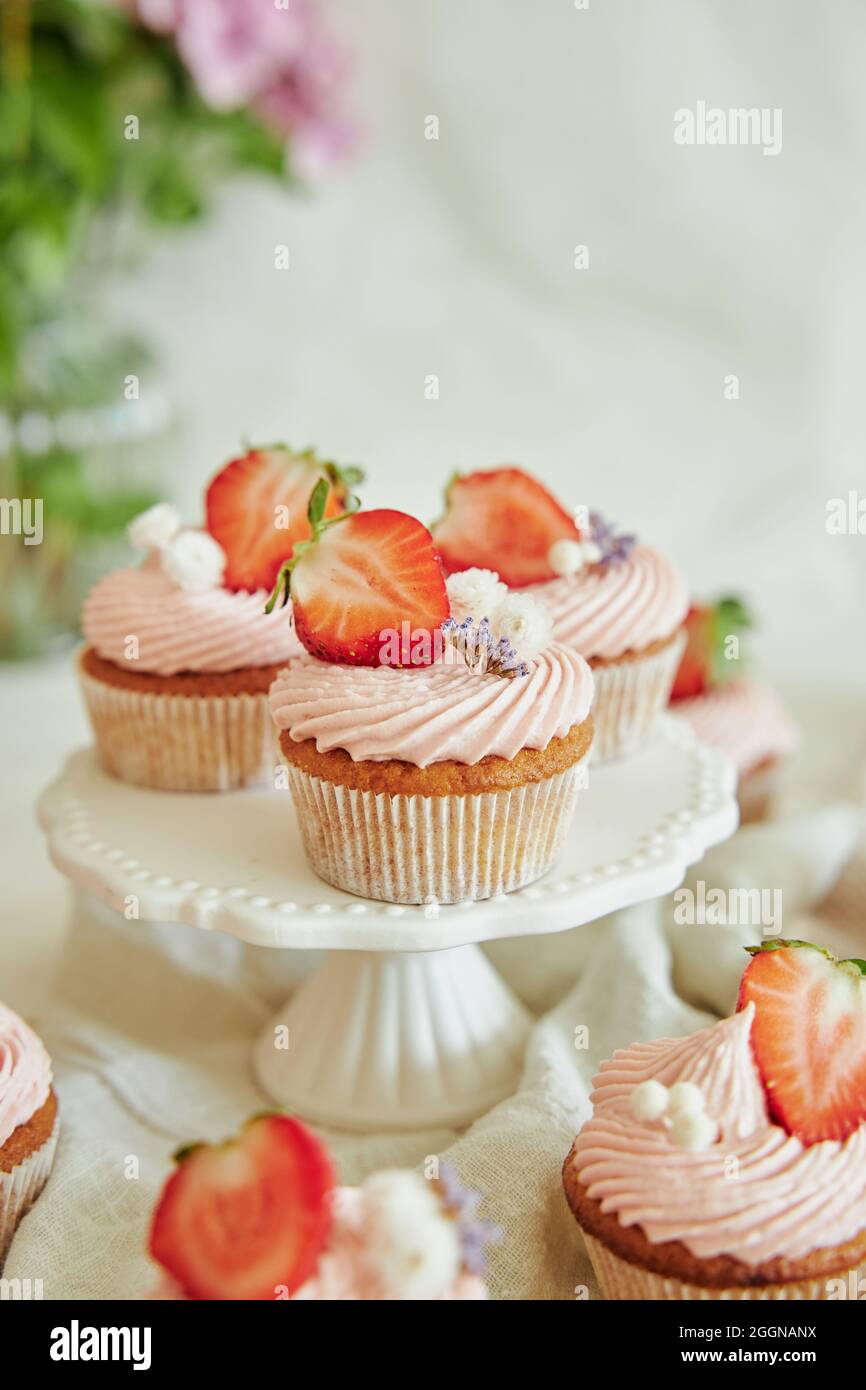 Vertical shot of delicious strawberry cupcakes Stock Photo - Alamy