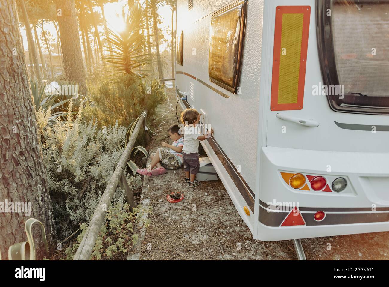 Two Boys In A Caravan playing in the nature Stock Photo - Alamy