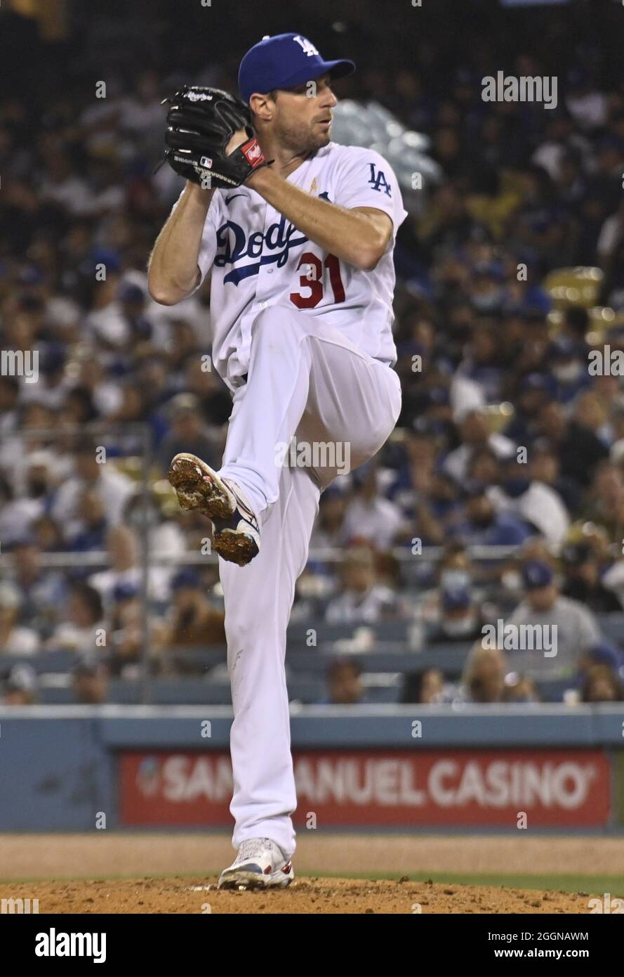 Los Angeles Dodgers' starting pitcher Max Scherzer winds up to deliver ...