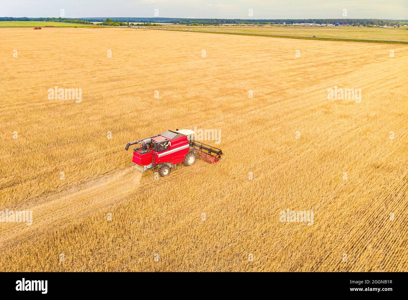 Agriculture machine harvesting crop in fields. Tractor pulls a ...
