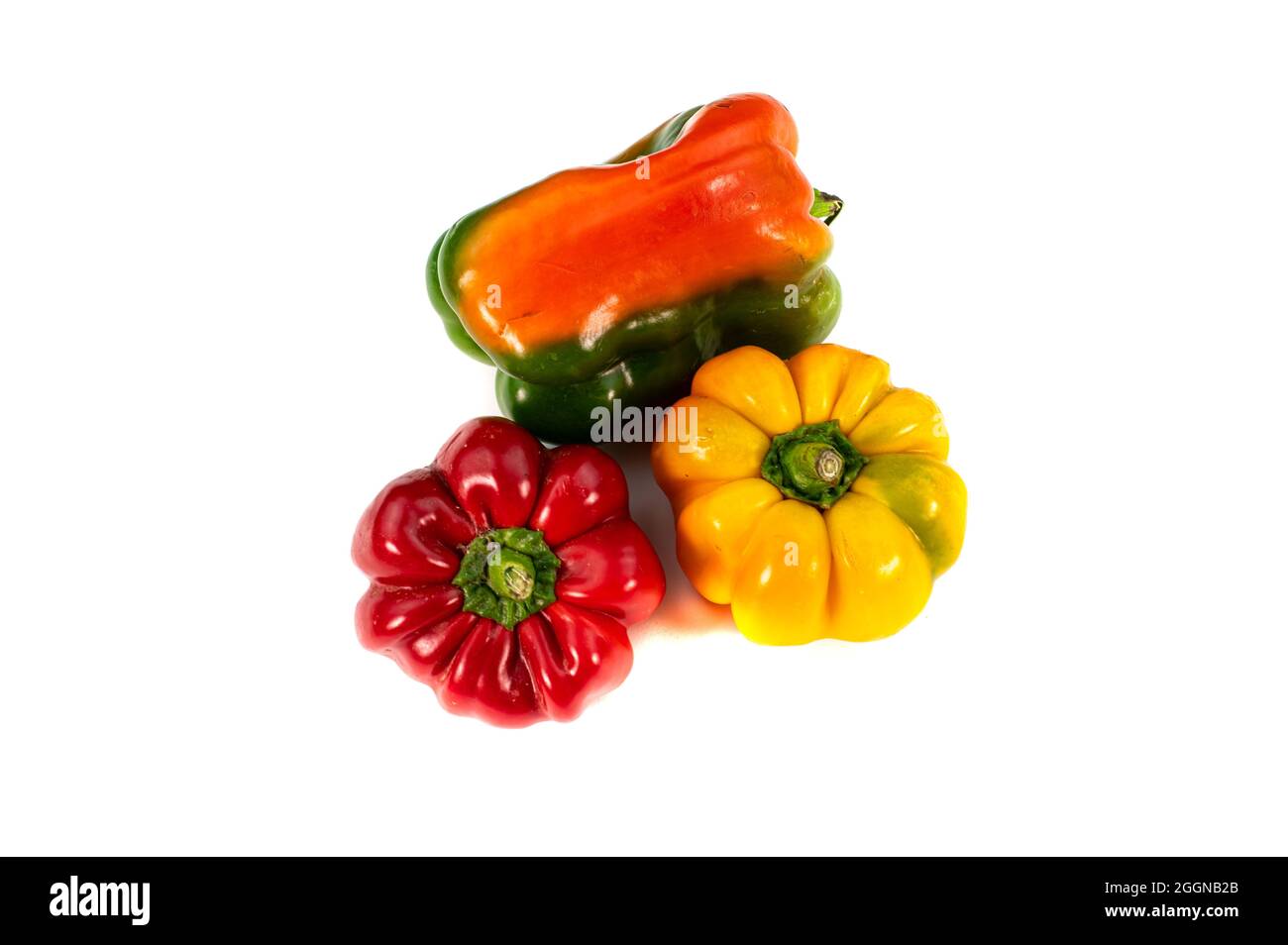 tris peppers of yellow and red color on a white background Stock Photo ...
