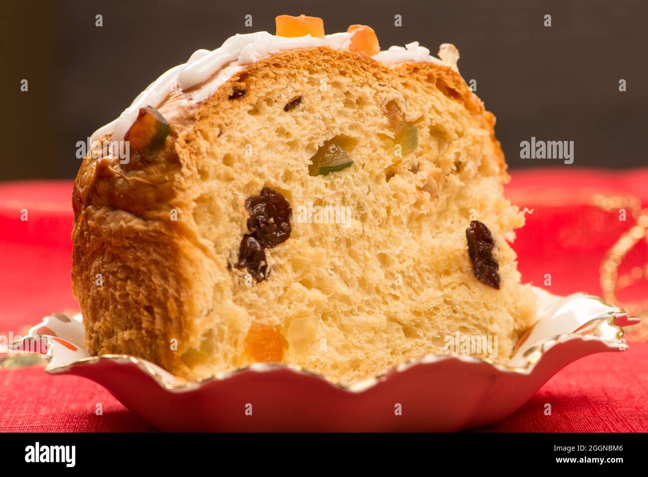 slice of panettone on red towel and black background Stock Photo - Alamy