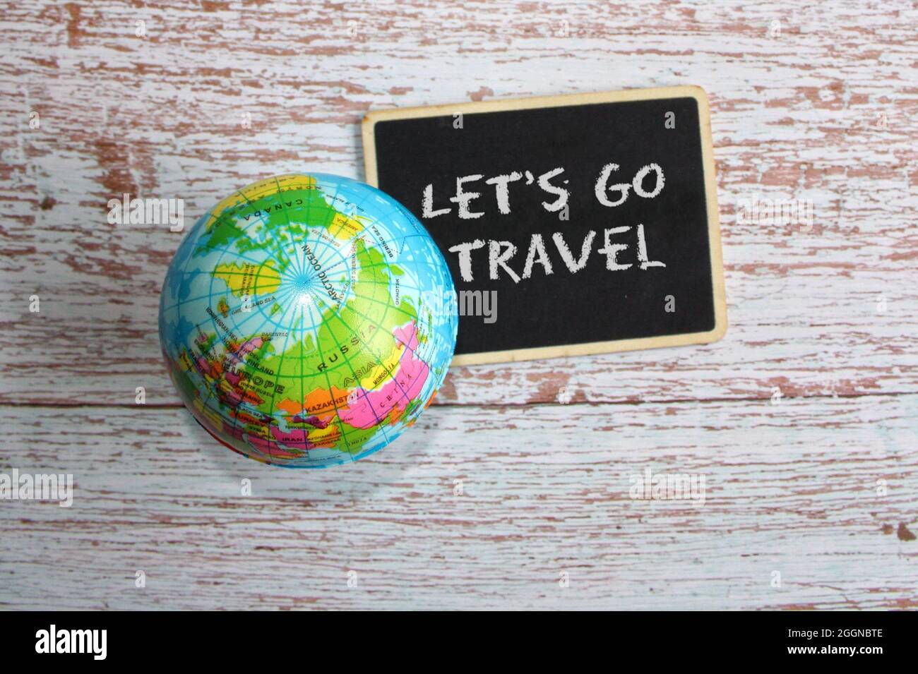 Earth map globe and blackboard with text LET'S GO TRAVEL Stock Photo ...